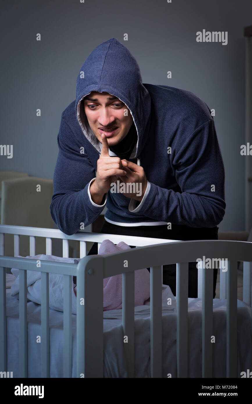 Criminal stealing baby in human child traficking concept Stock Photo ...