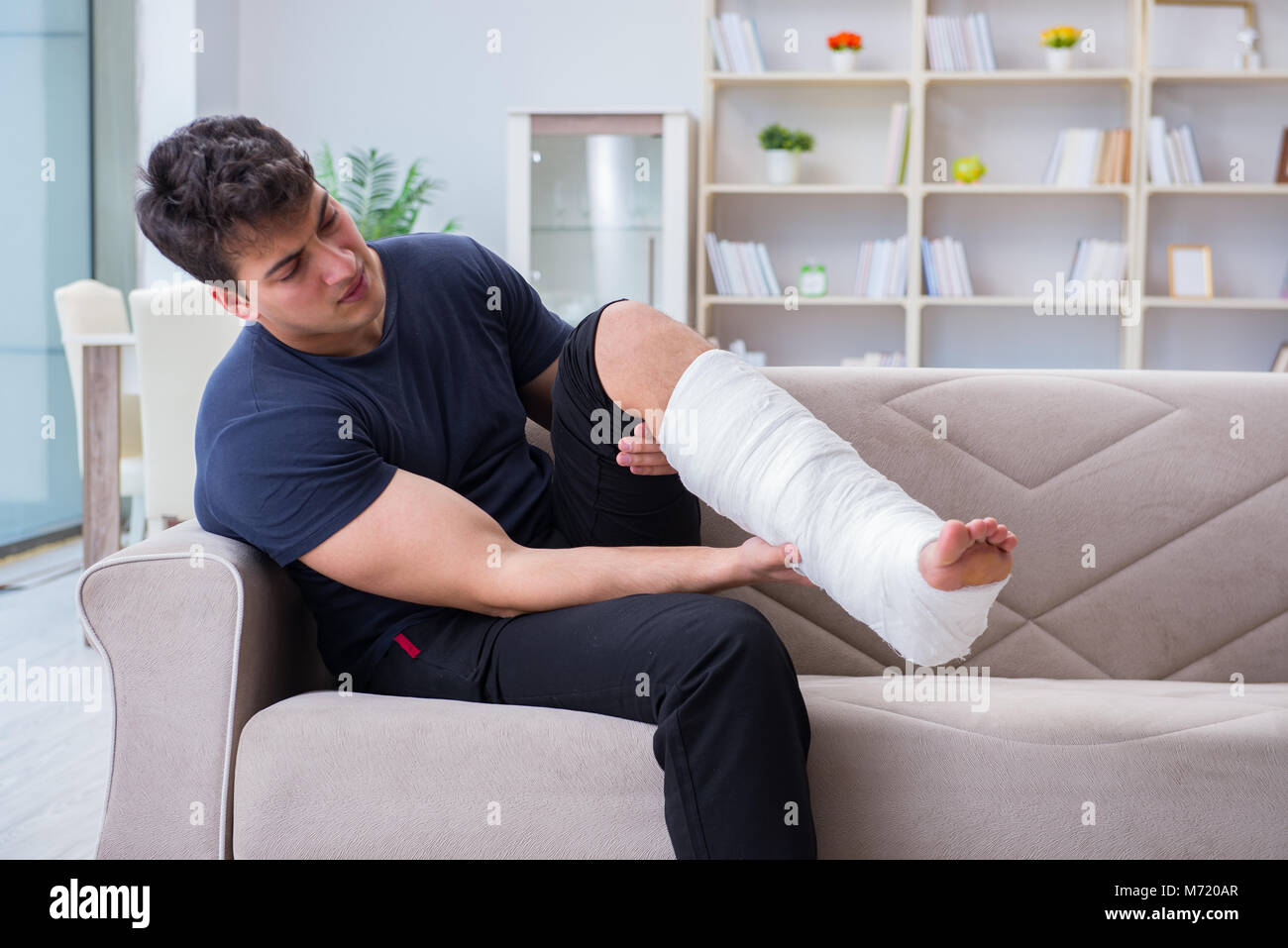 Man with broken leg recovering at home Stock Photo - Alamy