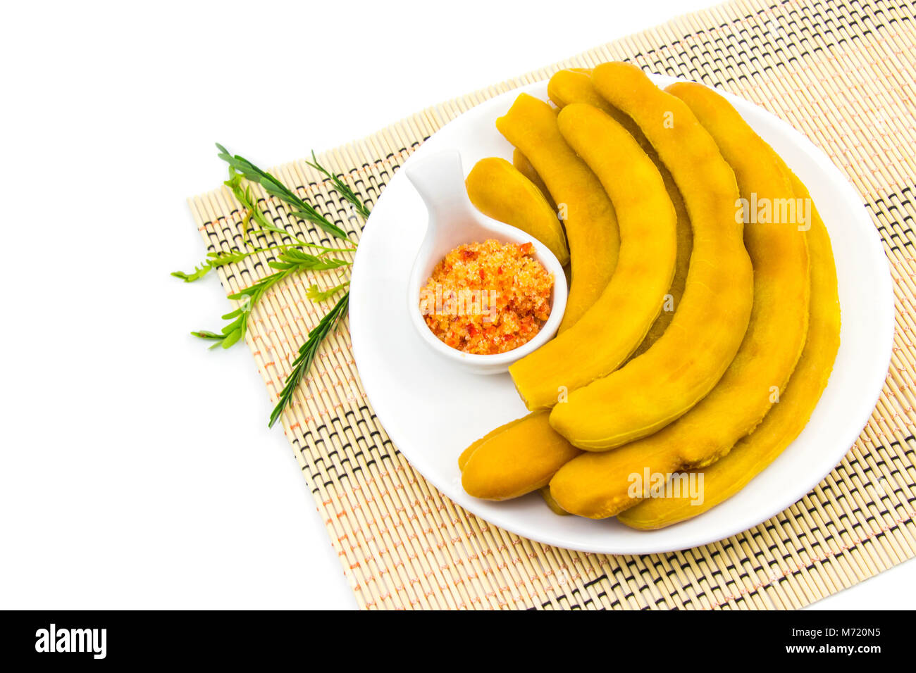 Pickled tamarind preserved in syrup on dish a white ceramic plate on ...