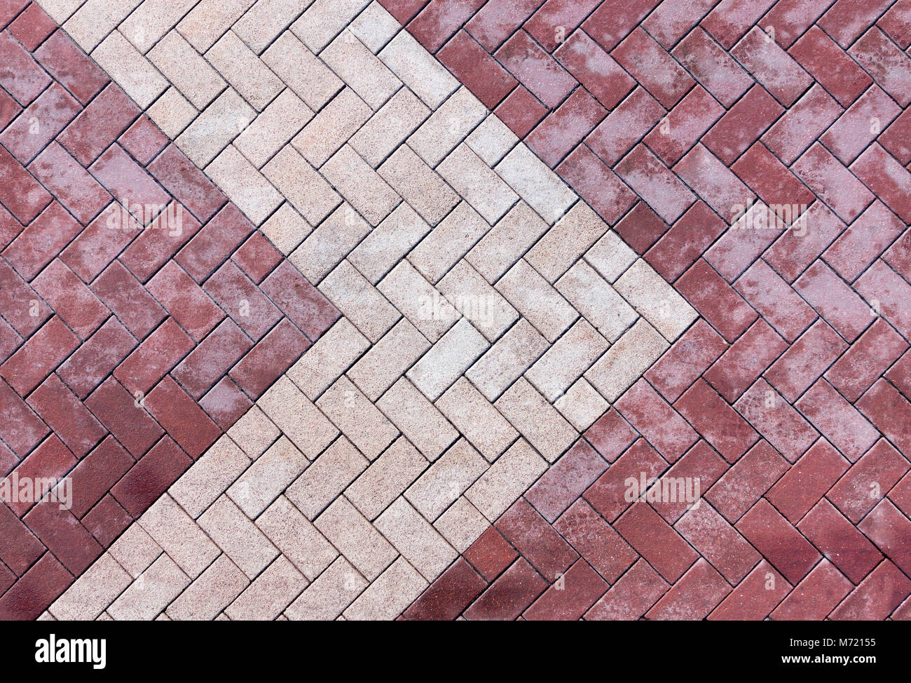Arrow white bricks red brick background Stock Photo - Alamy