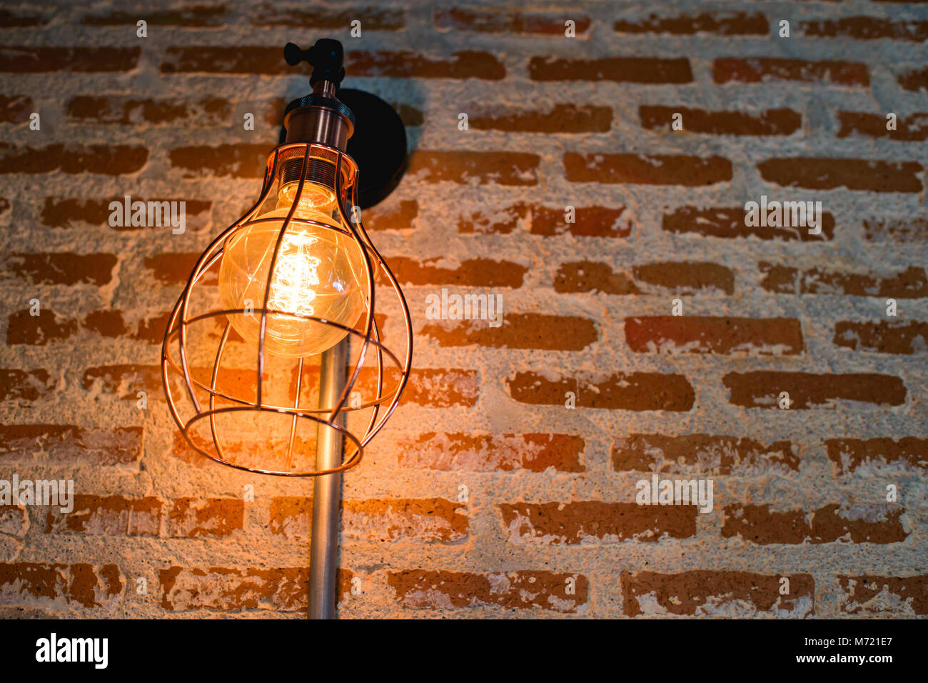 Decorative antique edison style light bulbs against brick wall ...