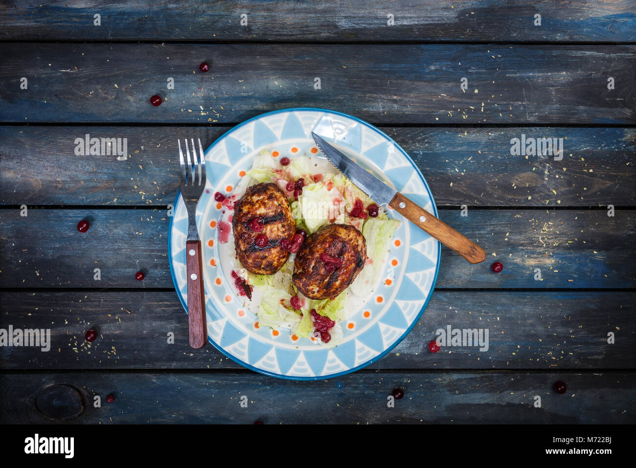 Turkey cutlets with a fresh berry saucea and iceberg salad served with ...