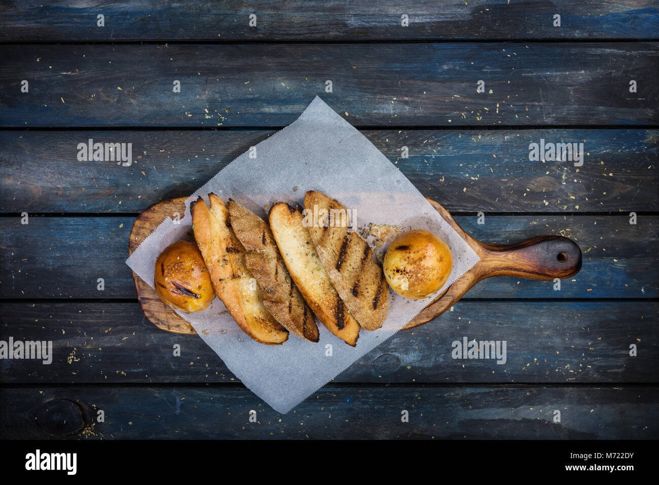 Grilled toasted bread on the cutting board Stock Photo - Alamy