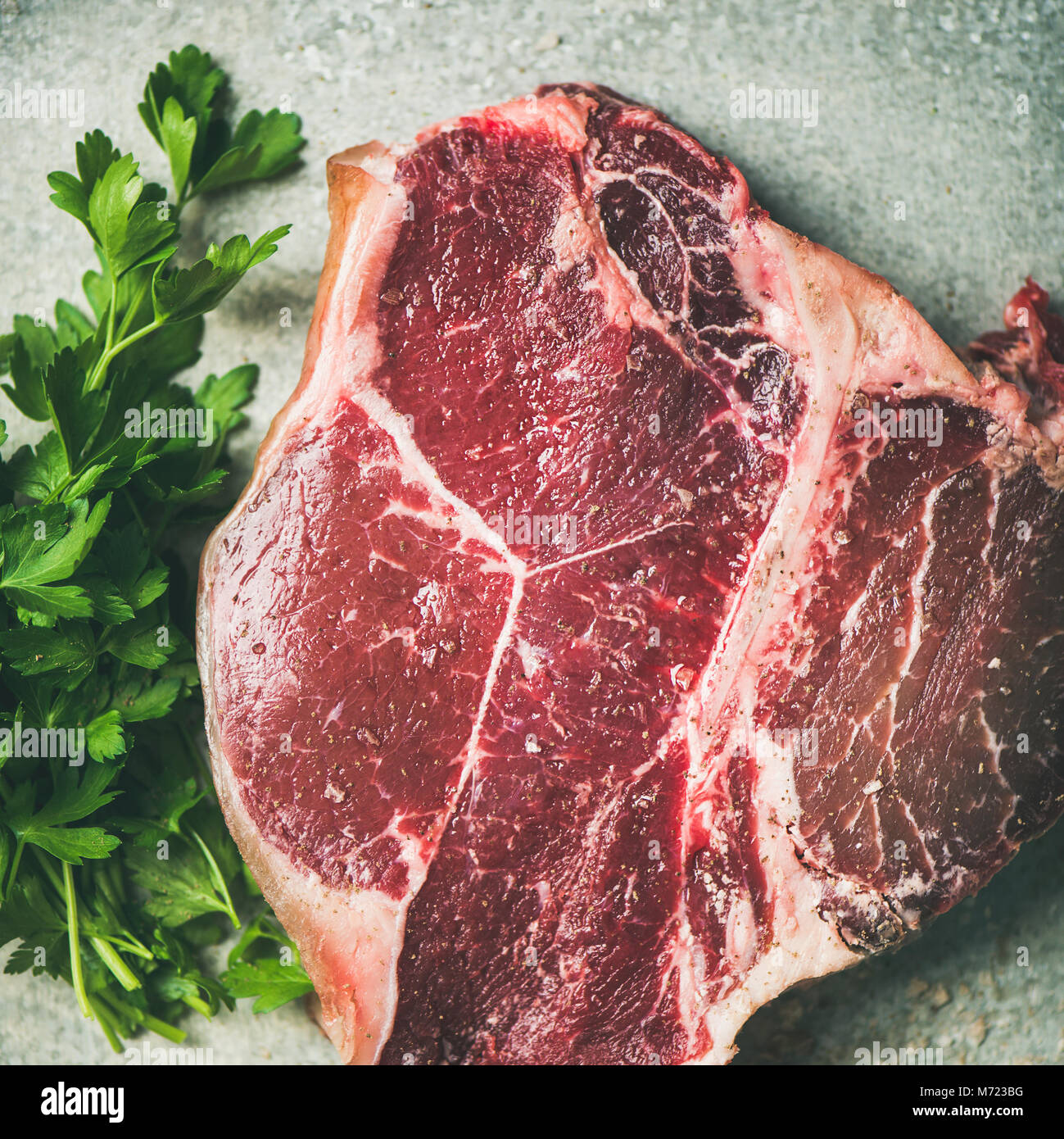 Flat-lay of raw uncooked dry-aged t-bone prime beef steak Stock Photo ...