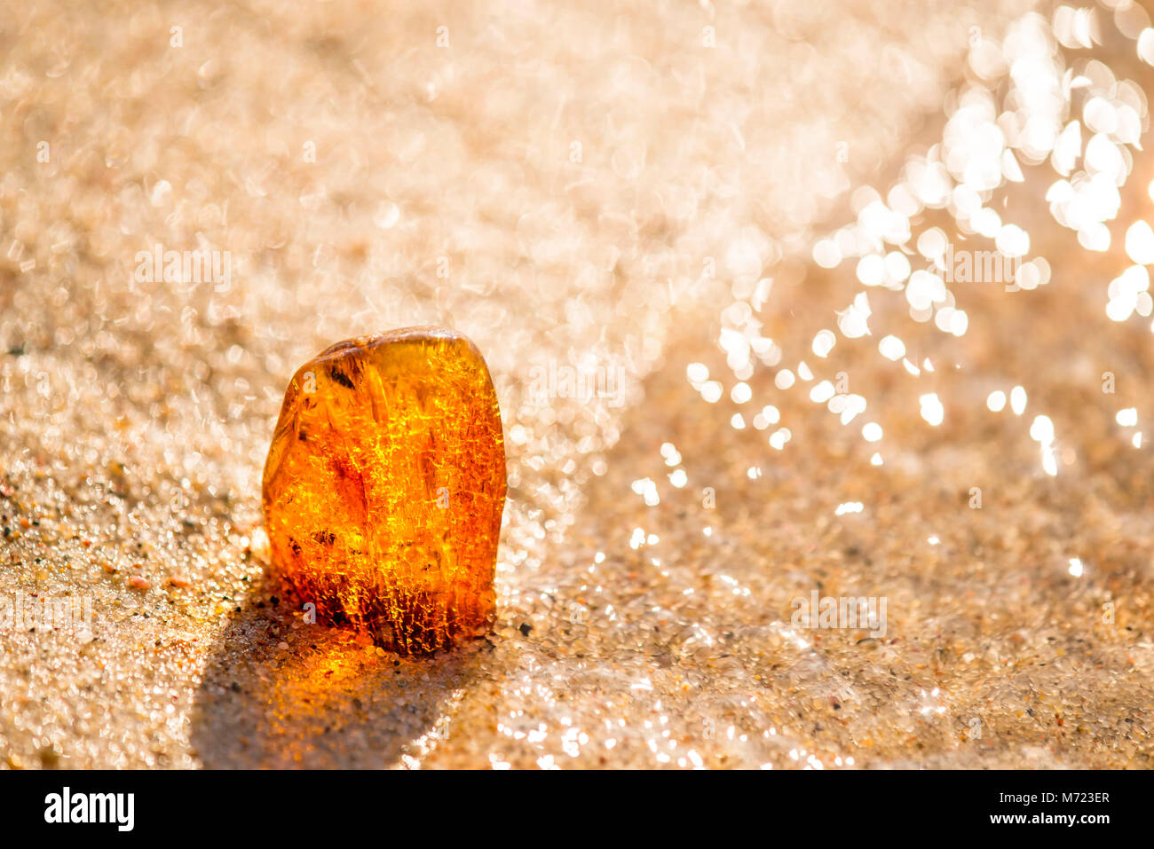 Amber on a beach of the Baltic Sea in the surf Stock Photo - Alamy