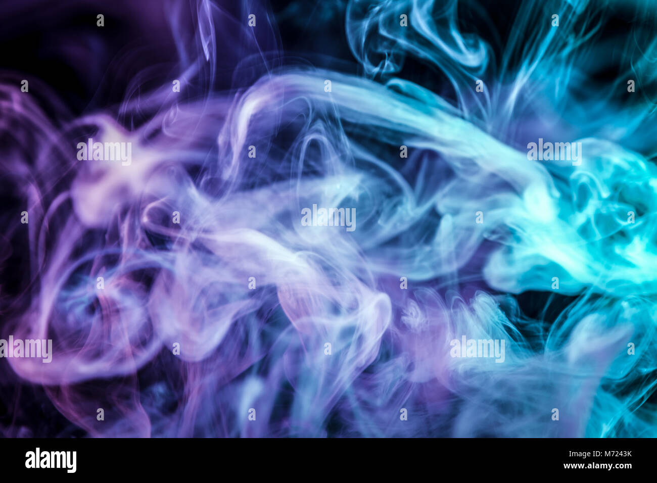 Colorful smoke of blue, pink, purple on a black isolated background ...