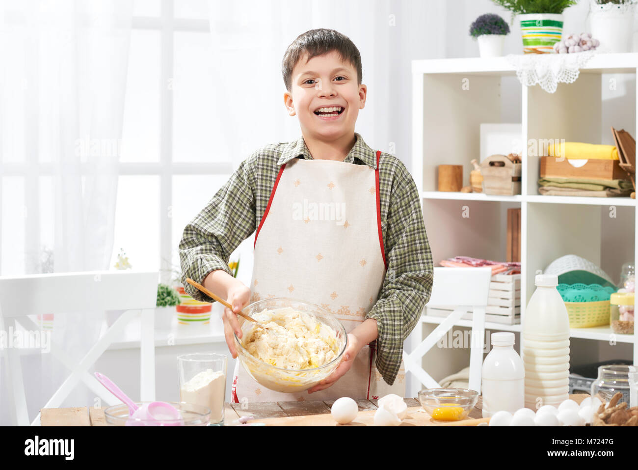 Boy cooking at home, making dough, buns and cookies Stock Photo - Alamy