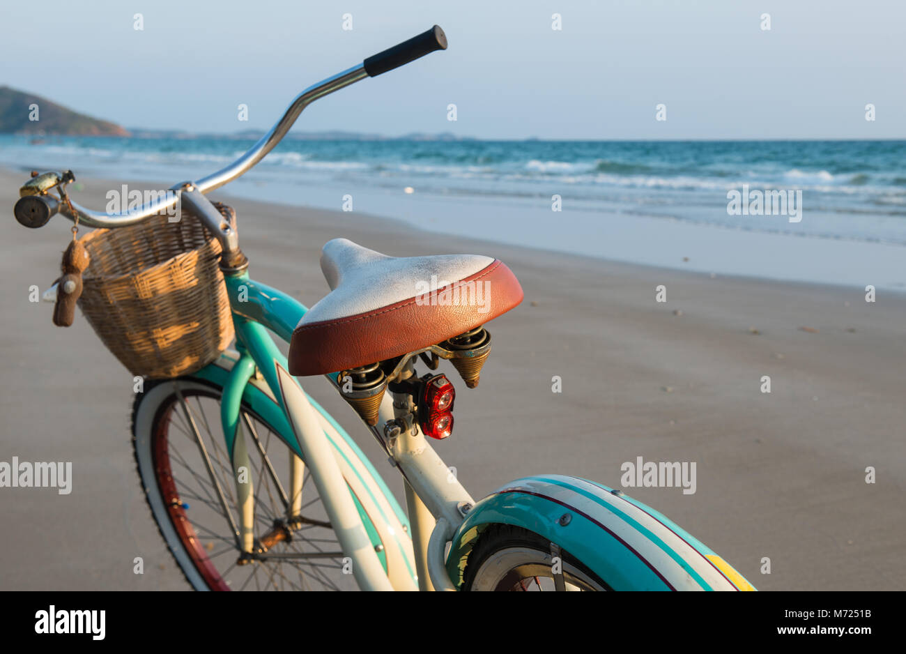 Seascape and the bicycle on the beach photo with ourdoor sunset low ...