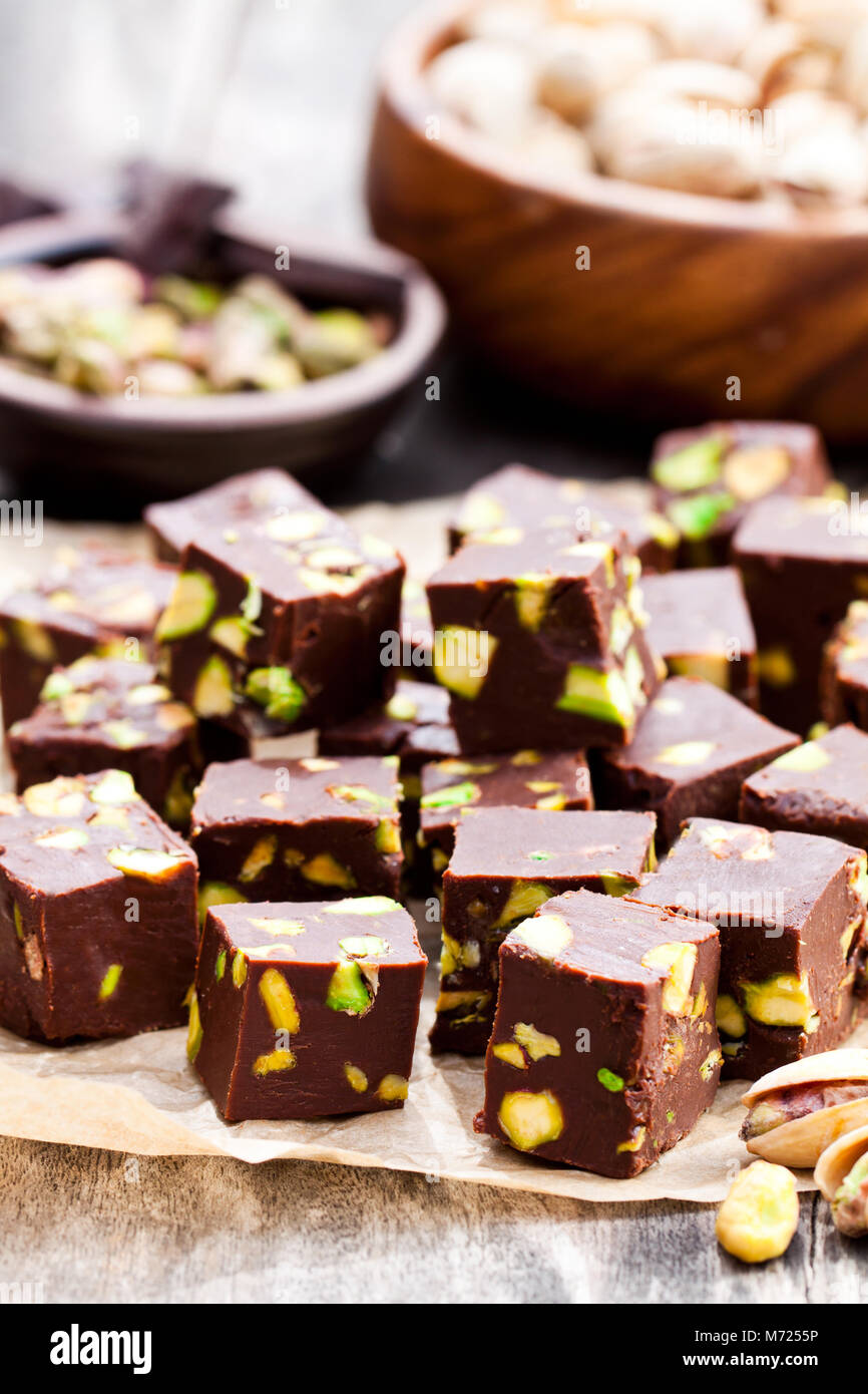 Dark chocolate cubes with pistachios on wooden background Stock Photo ...