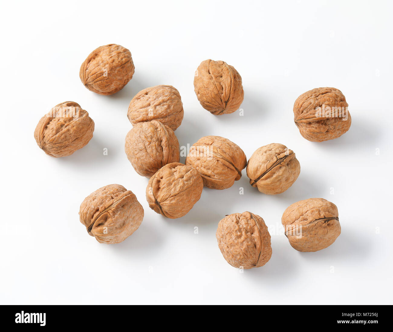 group of whole walnuts scattered on white background Stock Photo - Alamy