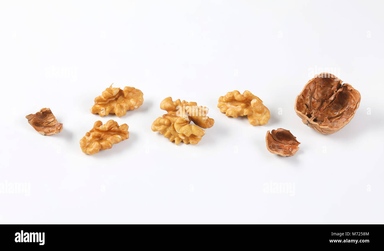 walnut kernels and shells on white background Stock Photo - Alamy