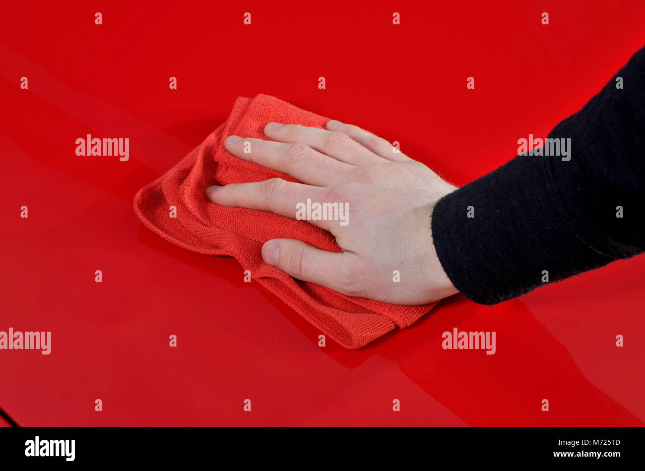 Polishing a red car with a red cloth Stock Photo - Alamy