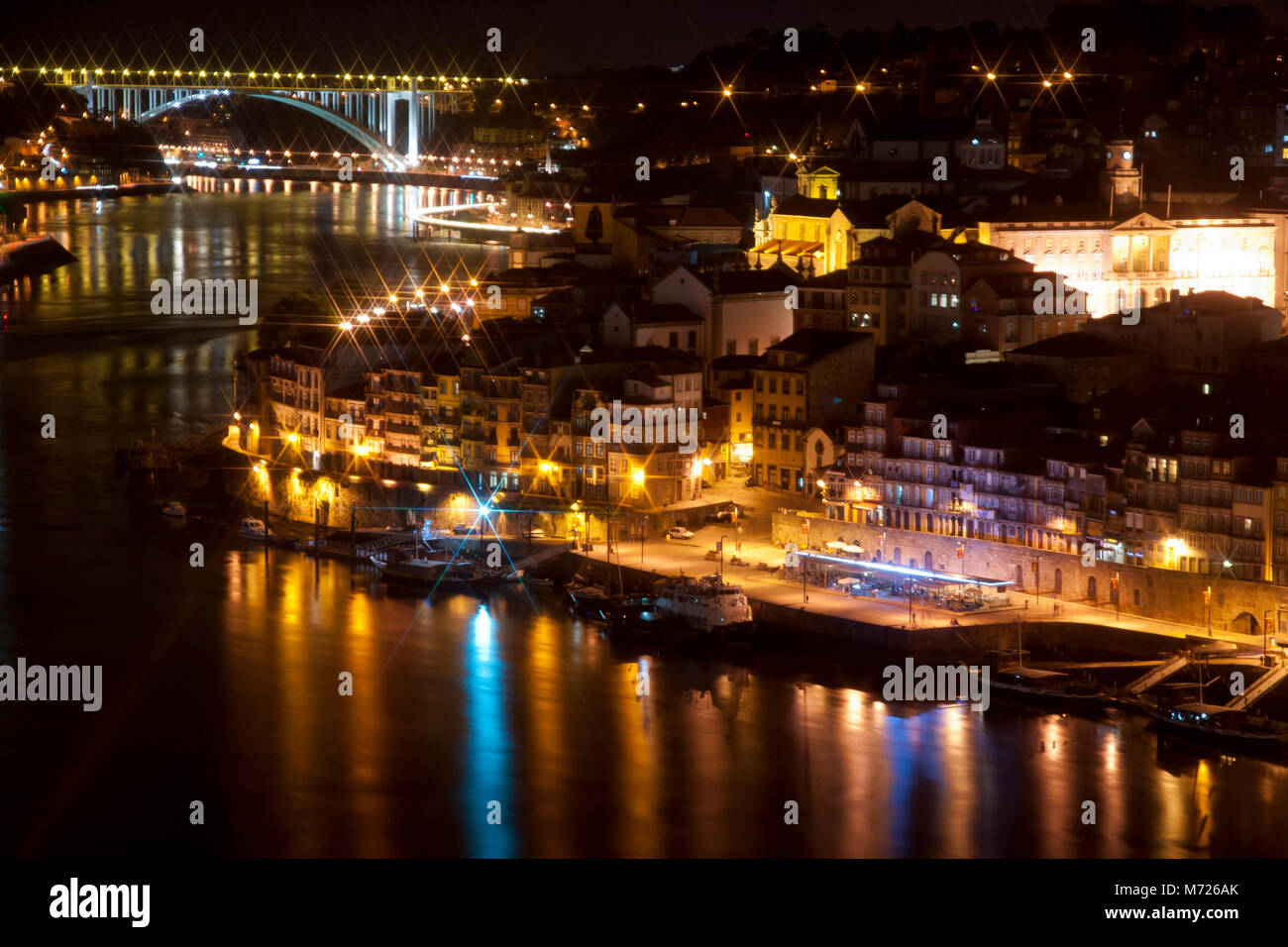 View to Porto over river Douro with reflection of the lights at night ...