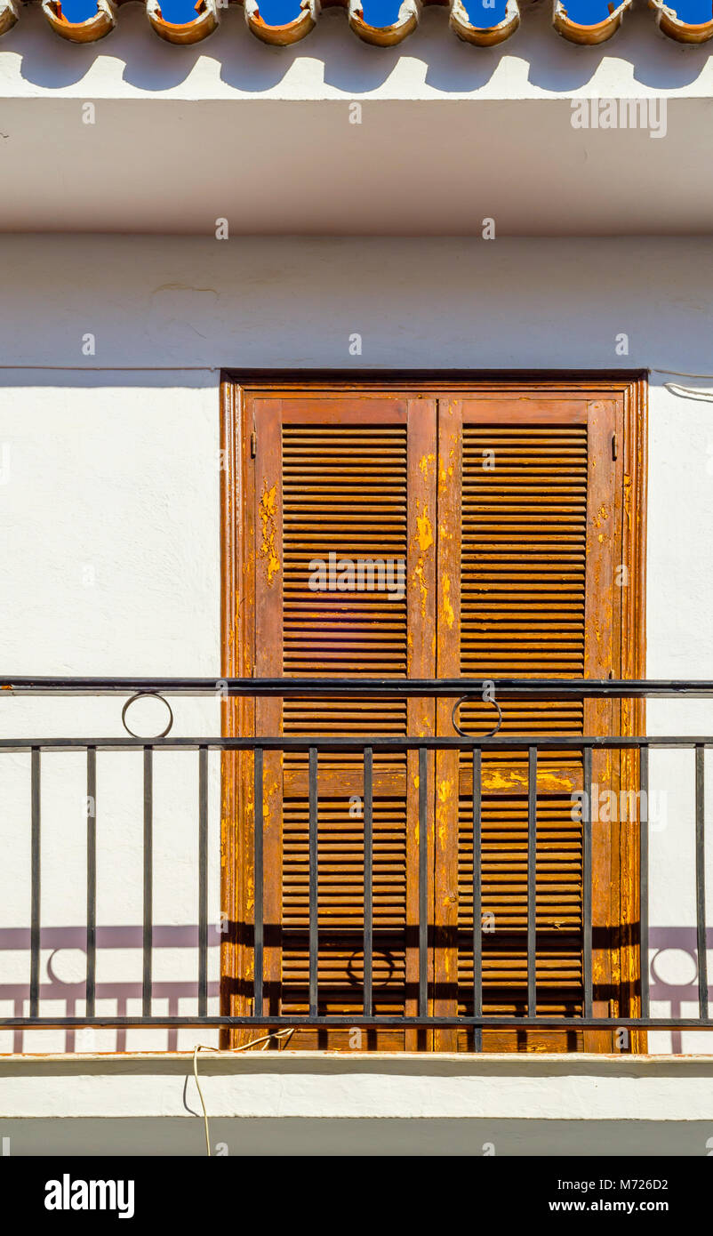 Stylish balcony with a metal railing, solid architectural element, a ...