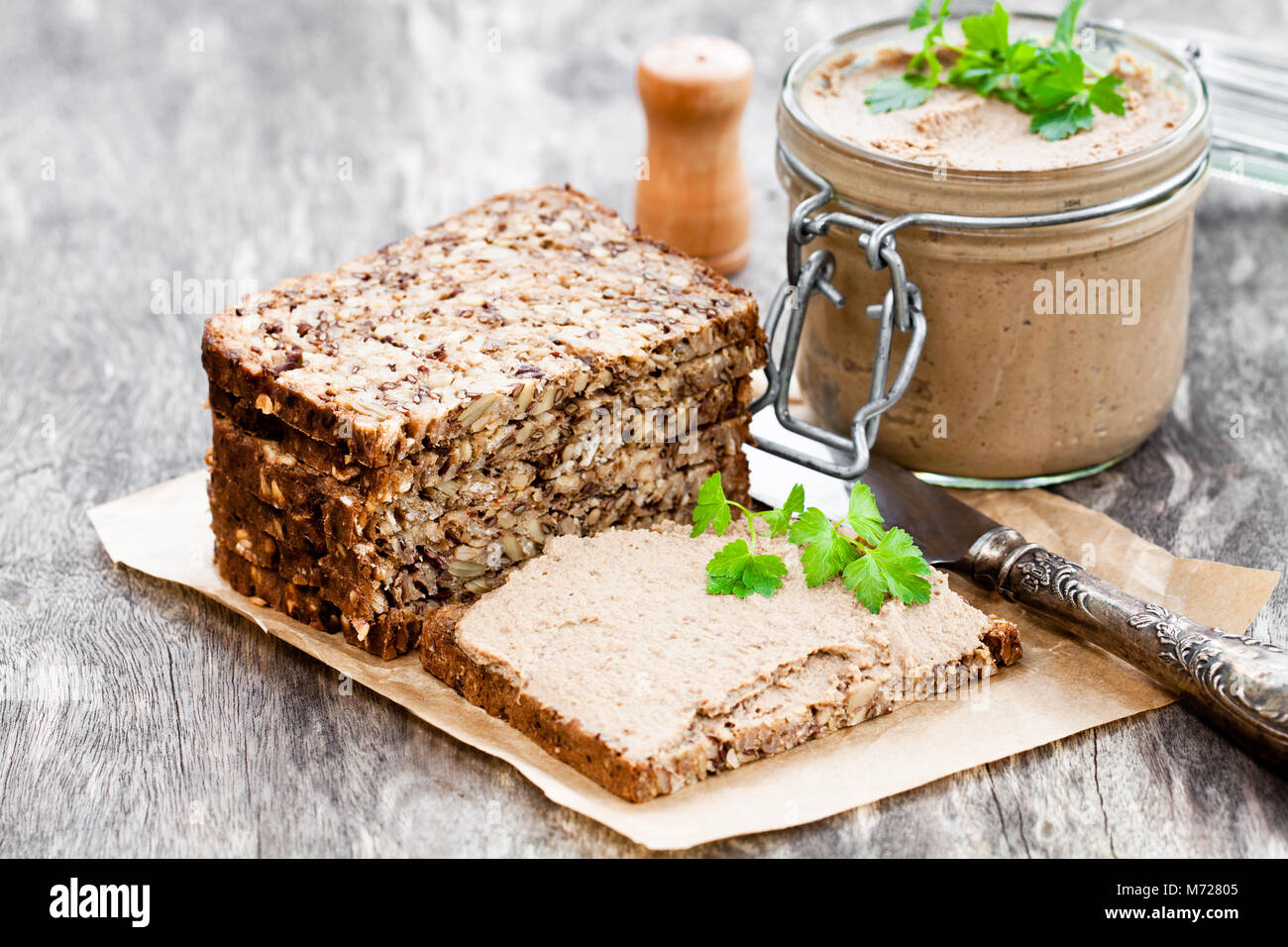 homemadeliver pate with parsley in a jar on a rustic wooden table Stock ...