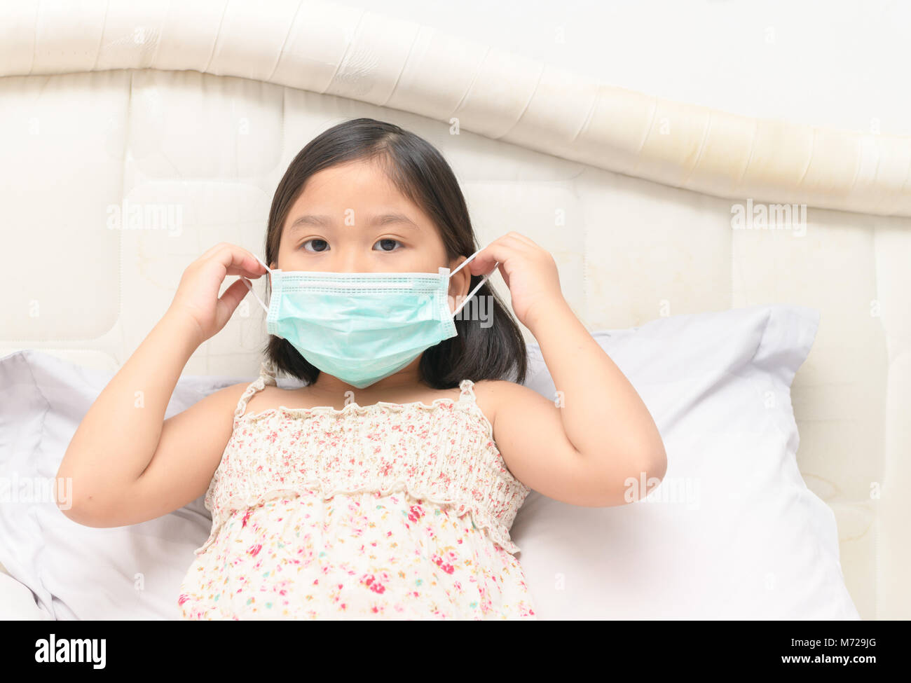 sick girl wear protection mask to protect against influenza virus in ...