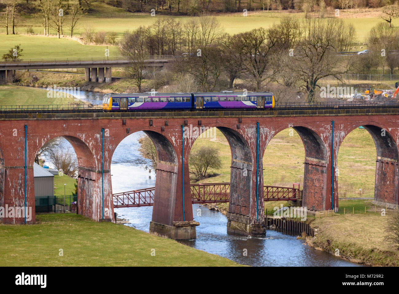 A Pacer diesel multiple unit train crossing the Whalley Arches viaduct ...