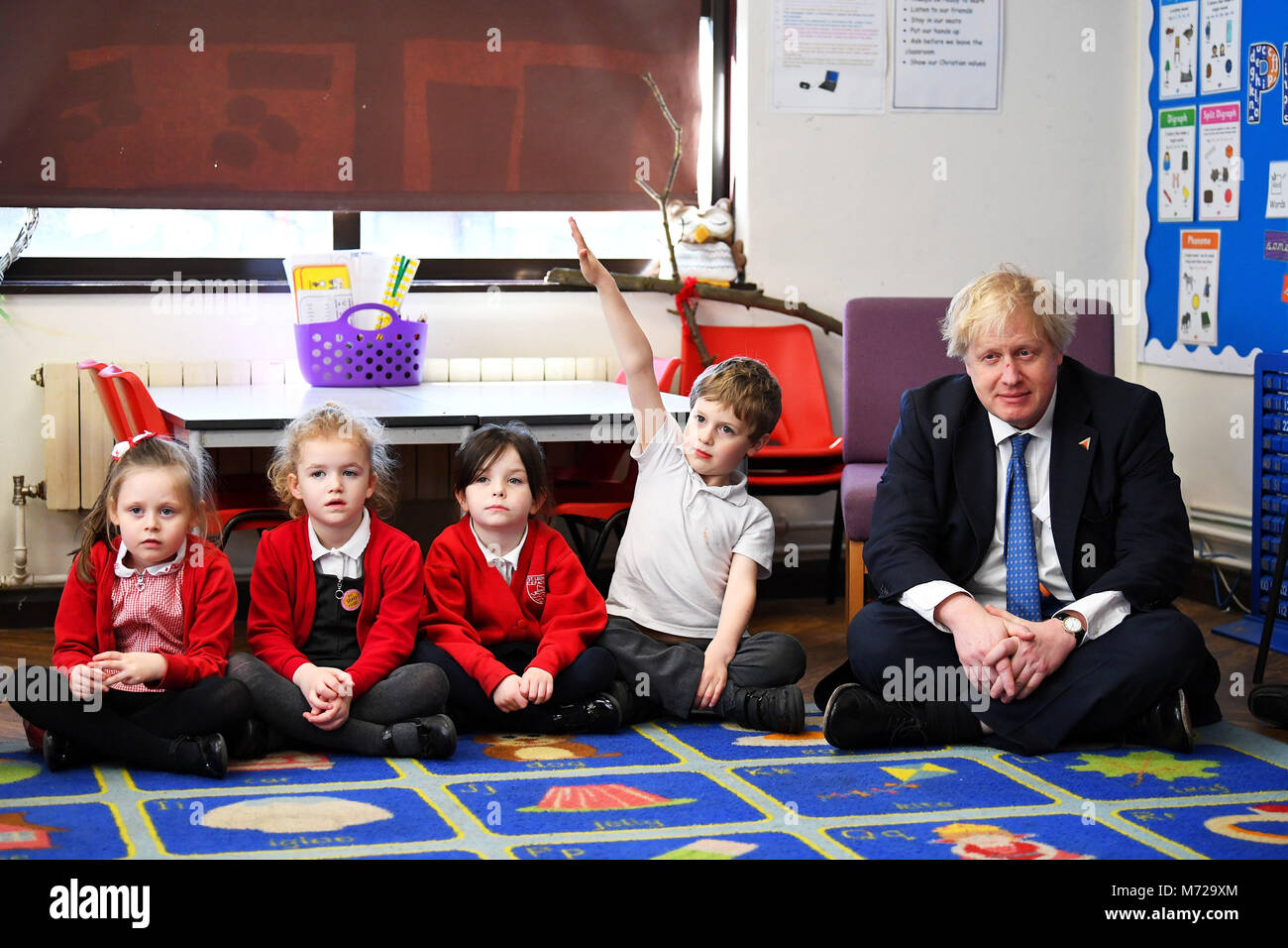 Foreign Secretary Boris Johnson sits with Year 1 pupils from the ...