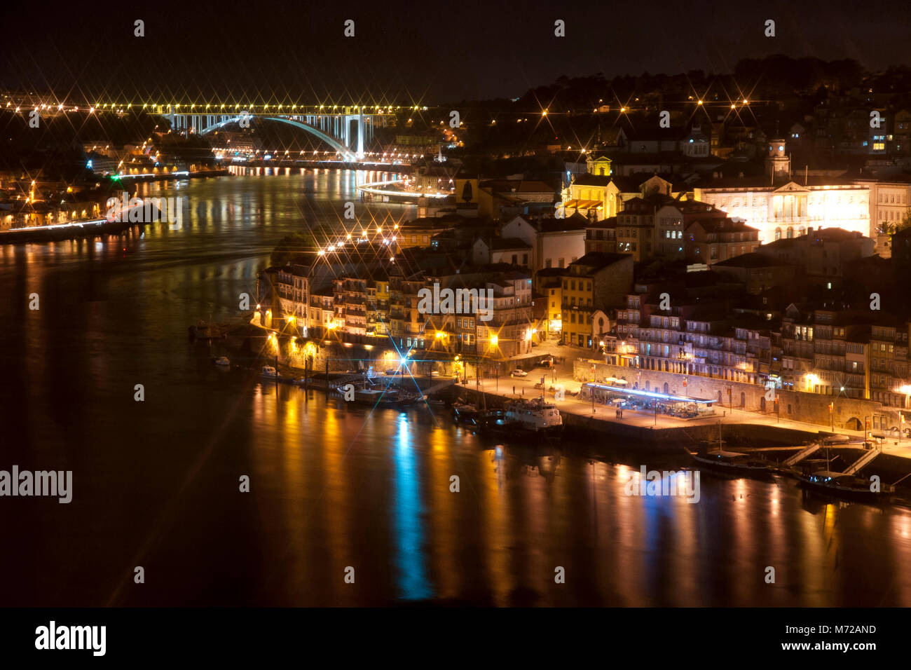 View to Porto over river Douro with reflection of the lights at night ...