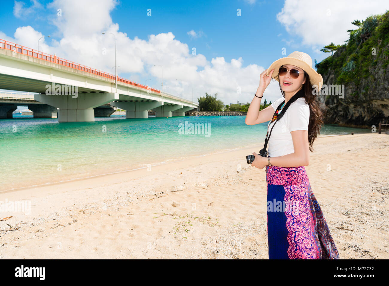 A young lady takes a walk aside Naminoue Beach, Japan. A student field ...