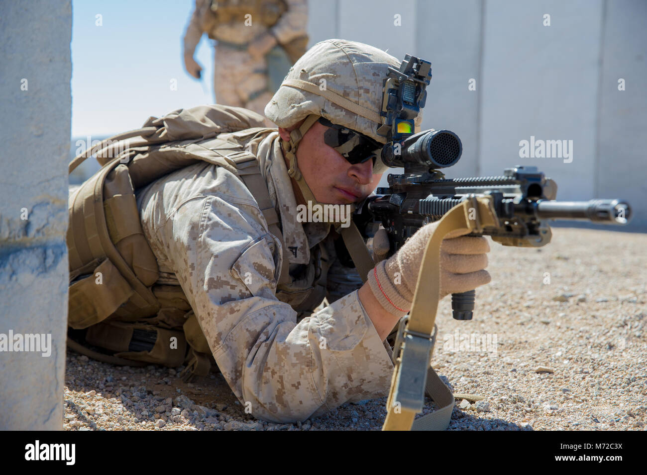 A Marine with 3rd Battalion, 4th Marines, 7th Marine Regiment, sights ...