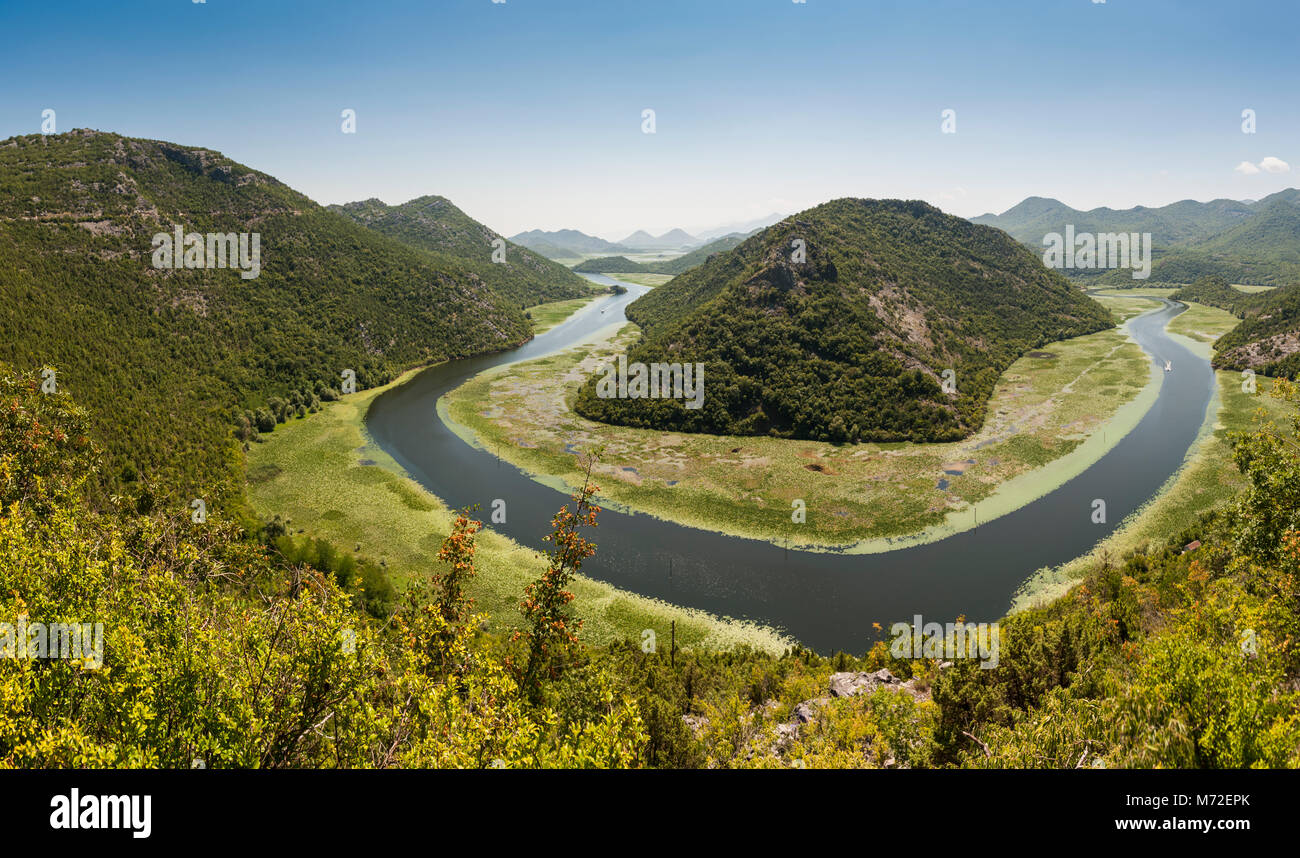 Beautiful green pyramid schape at the Rijeka Crnojevića river in ...