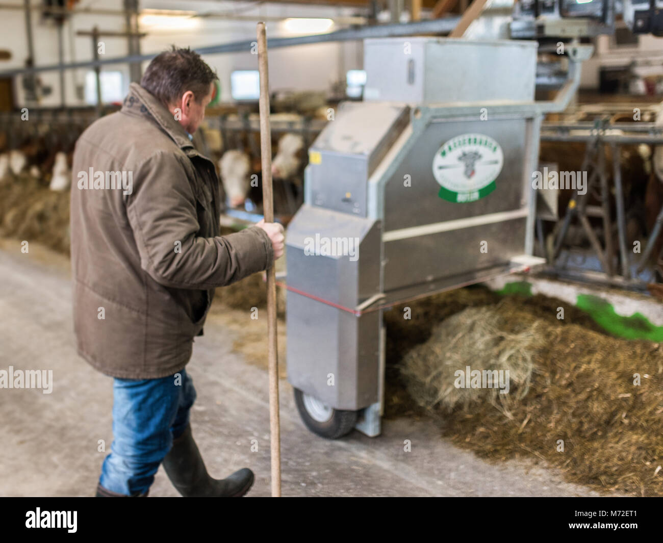 Farmer stable work 2 Stock Photo - Alamy