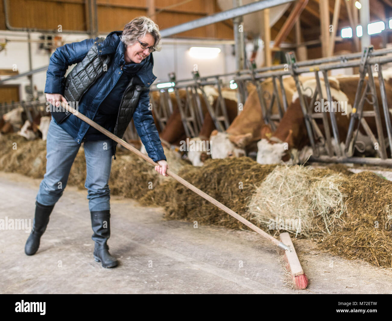 Farmers wife stable work 1 Stock Photo - Alamy