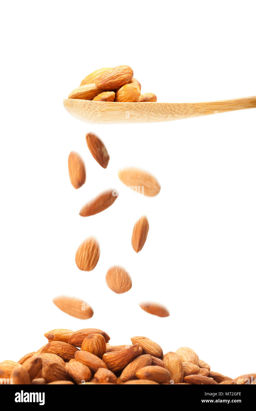 Sprinkle almonds seed from spoon isolated on white background Stock ...