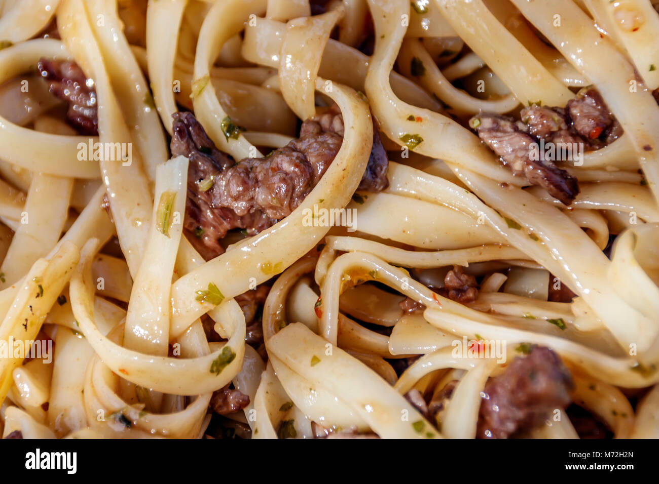 Spaghetti with slices of meat top view close-up Stock Photo - Alamy
