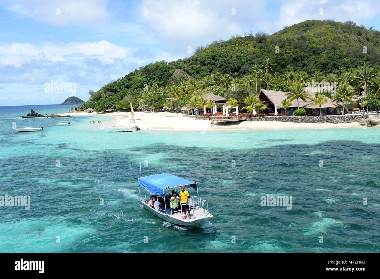 Small boats transfer tourists from bigger boats to the beach on ...