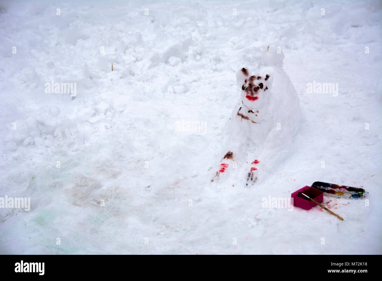A terrible ugly snowman sculpted from the snow by children against the ...
