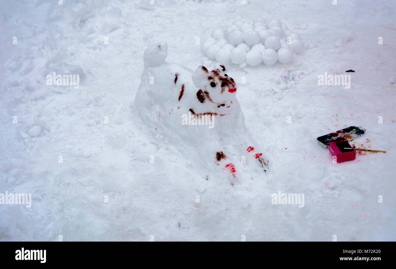 A terrible ugly snowman sculpted from the snow by children against the ...