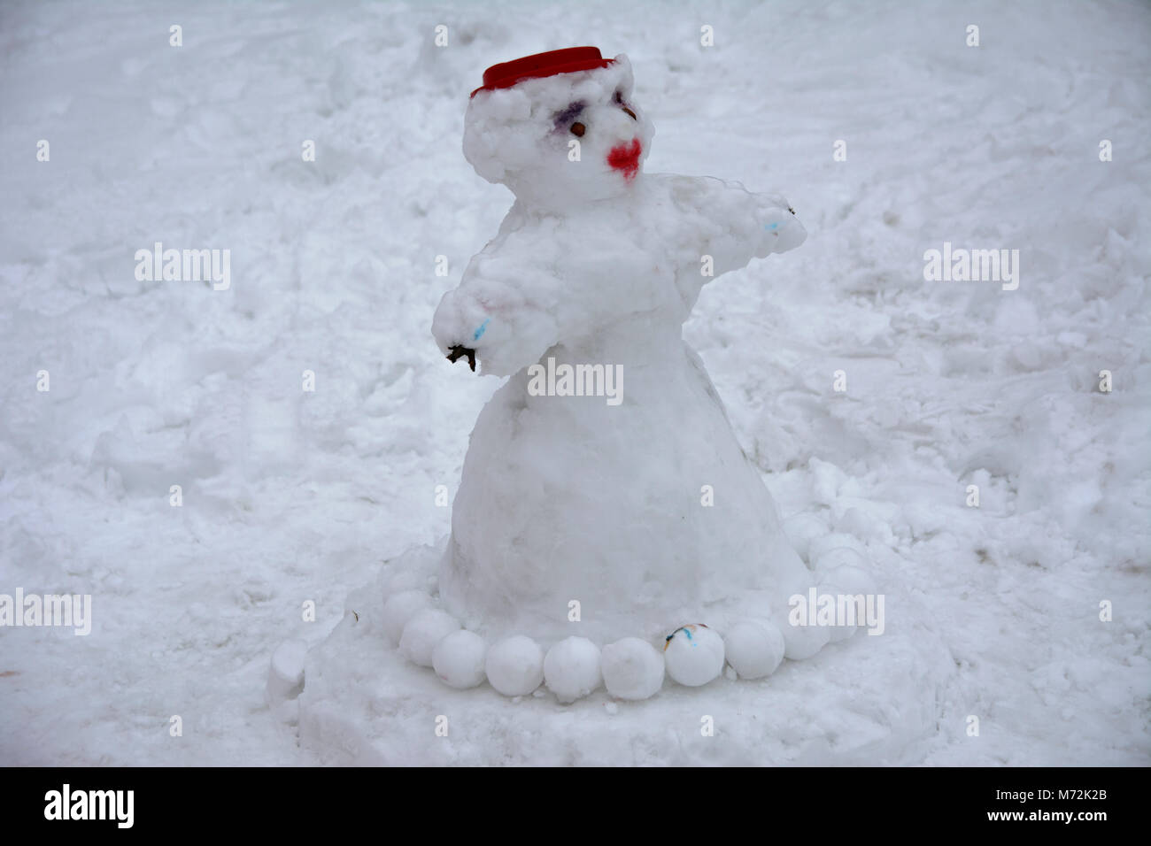 A terrible ugly snowman sculpted from the snow by children against the ...