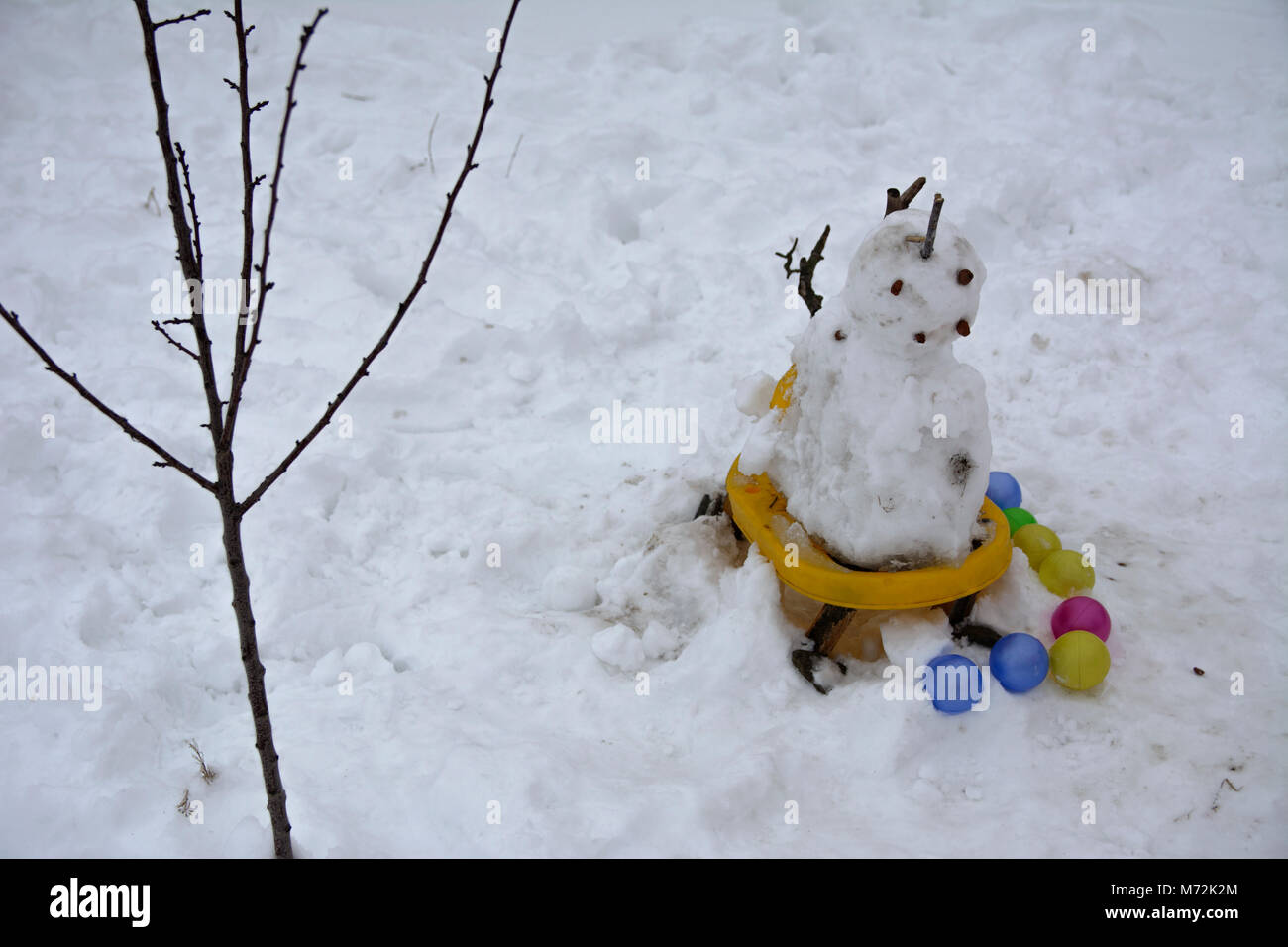 A terrible ugly snowman sculpted from the snow by children against the ...