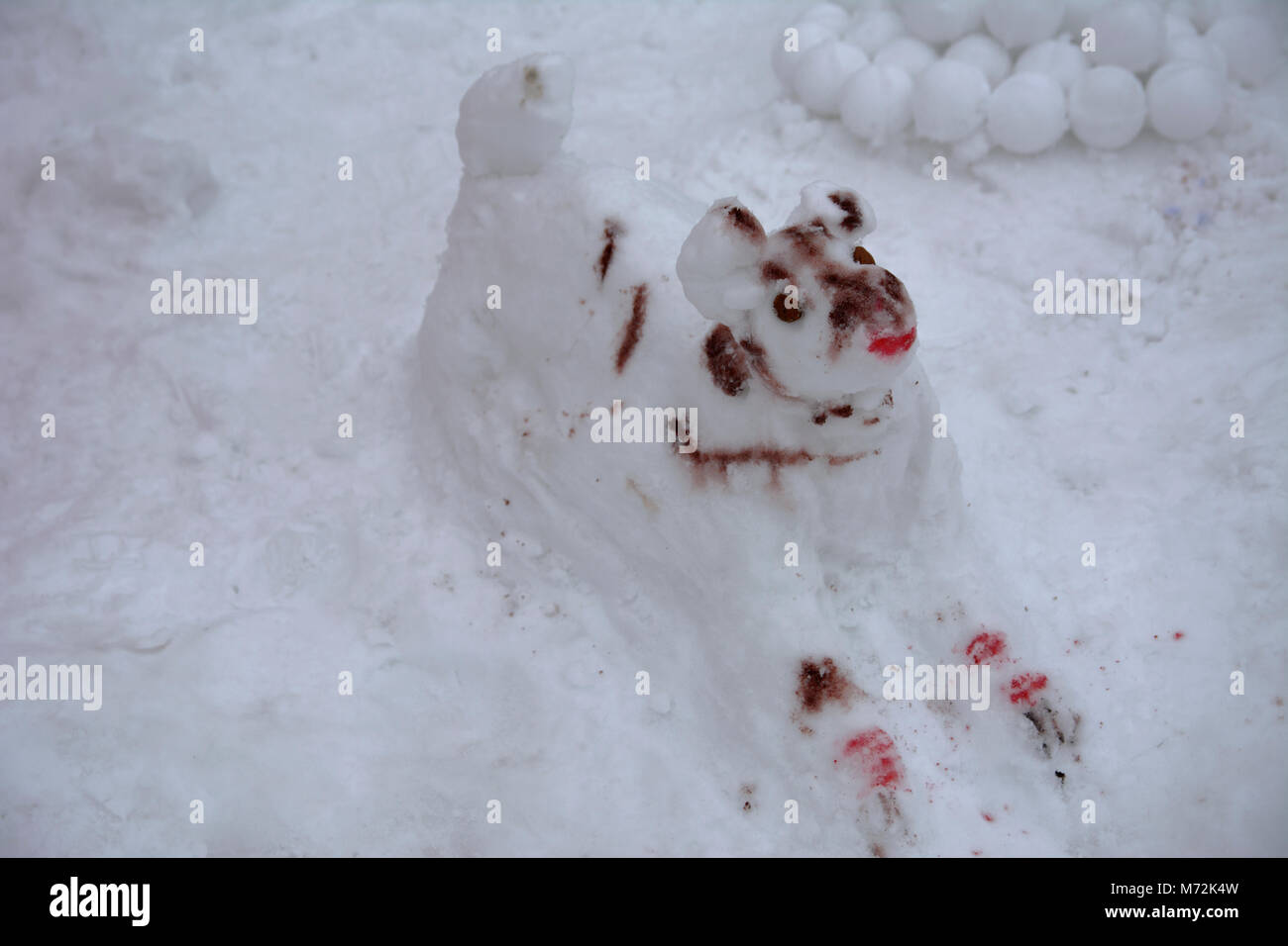 A terrible ugly snowman sculpted from the snow by children against the ...