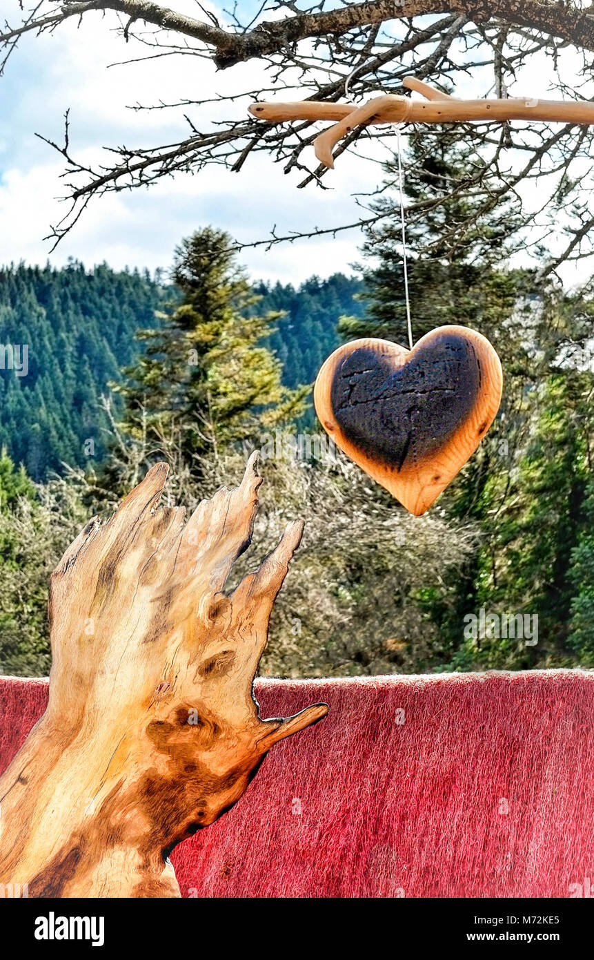 Burning heart. Wooden creations. A piece of wood like a human hand ...