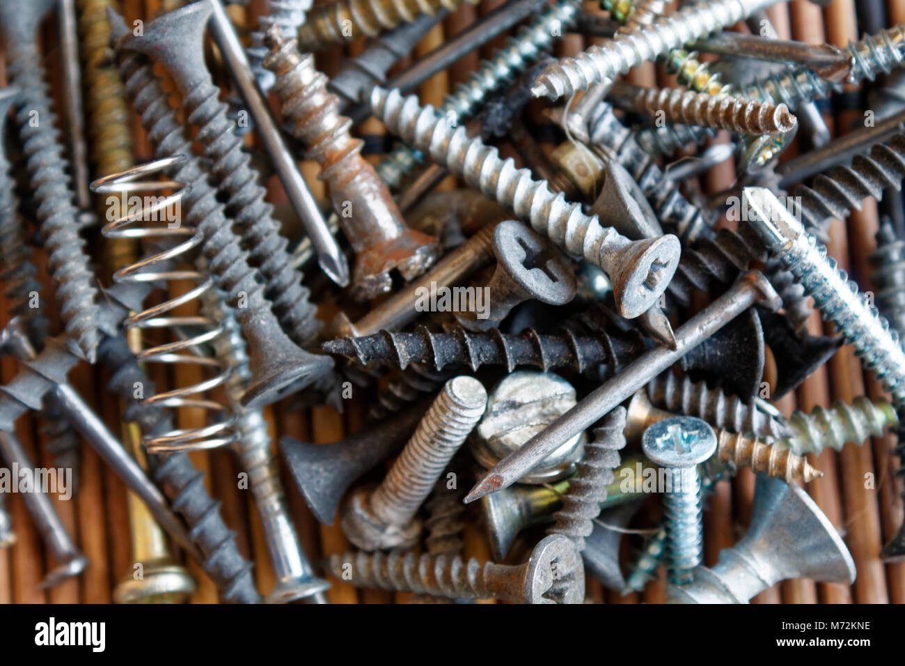 Scattered Screws and bolt isolated on wooden background Texture for web ...