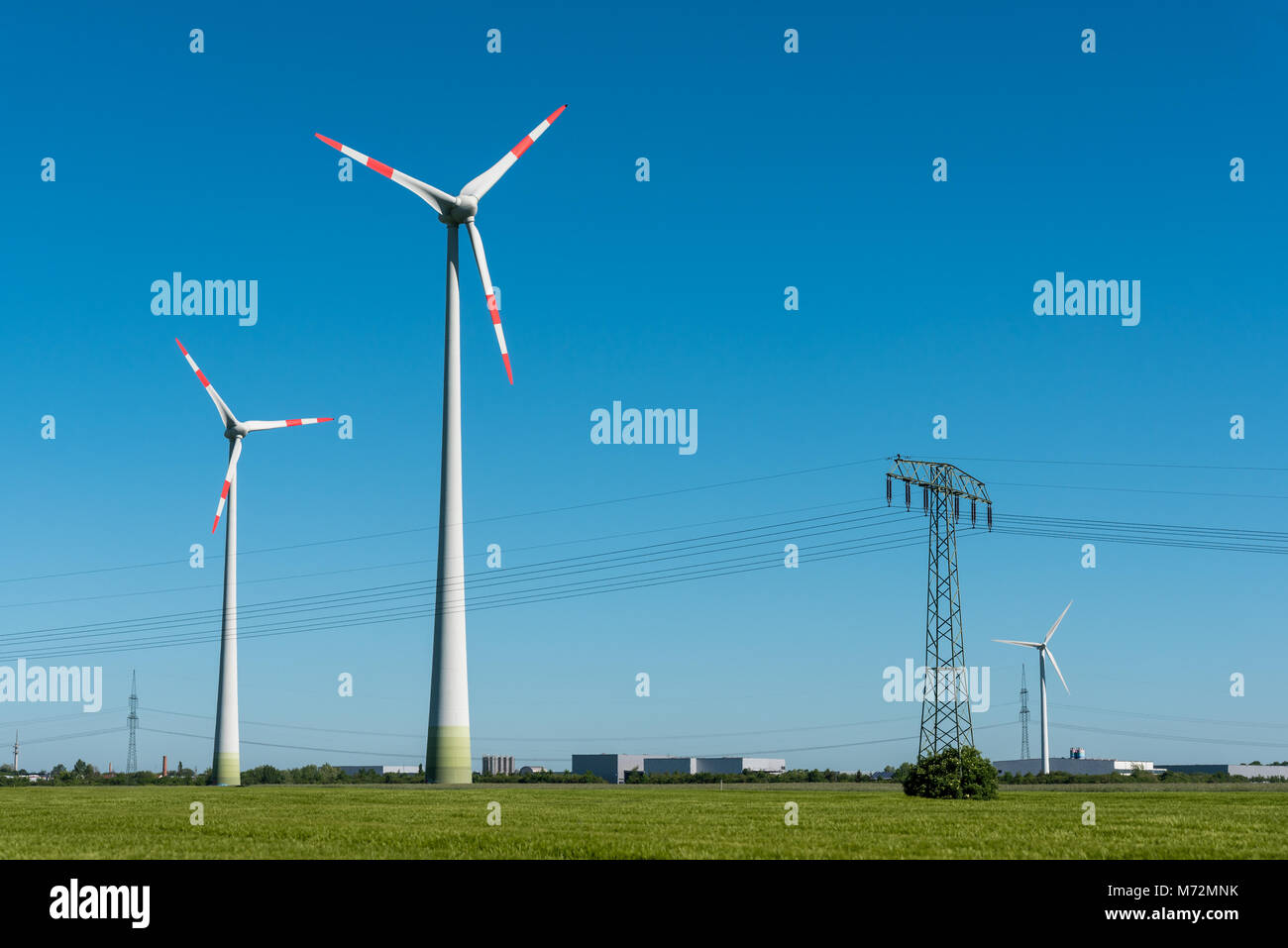 Wind turbines and overhead lines on a sunny day seen in Germany Stock ...