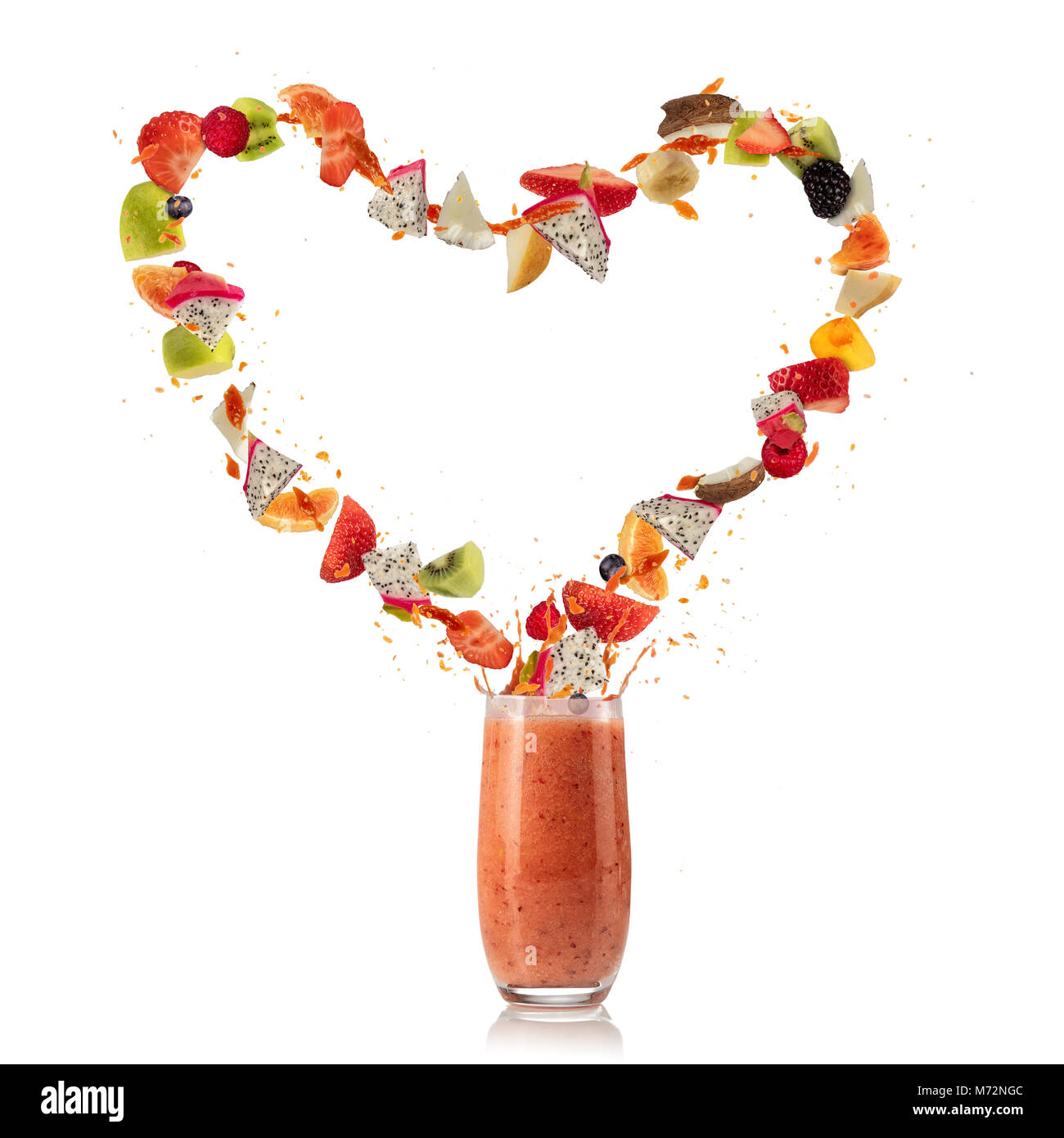 Smoothie drink with fruit flying ingredients in heart shape, isolated ...