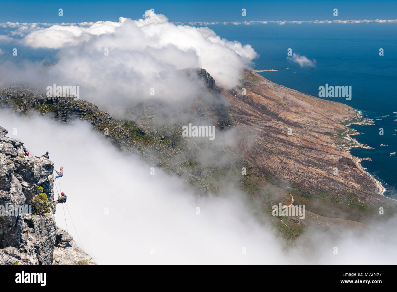 Abseilers abseiling off the summit of Table Mountain with Cape Town’s ...