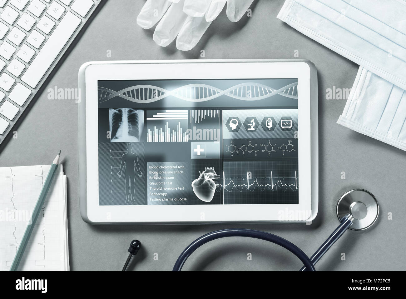 White tablet pc and doctor tools on gray surface Stock Photo - Alamy