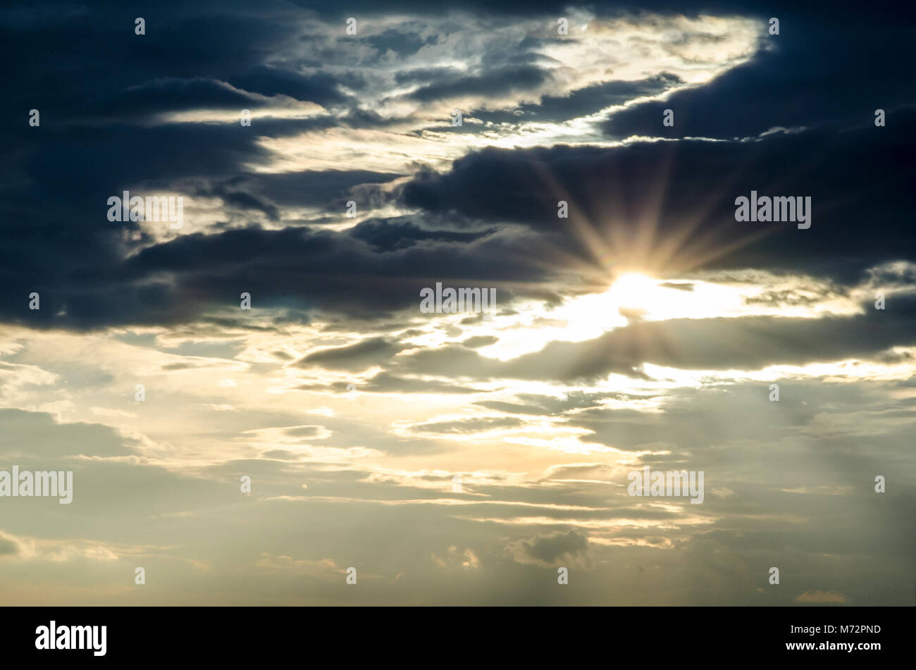 Dark storm sky with sun rays Stock Photo - Alamy