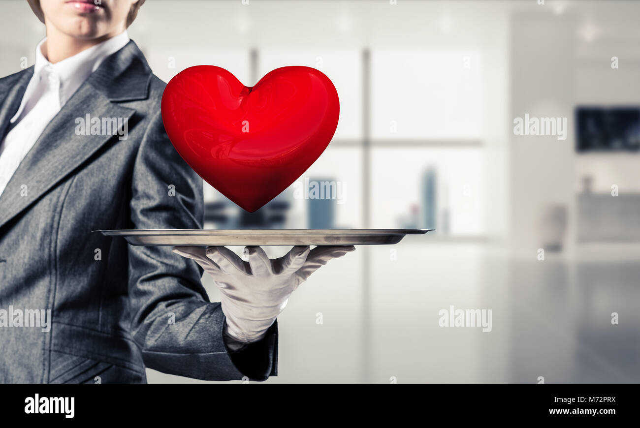 Cropped image of waitress's hand in white glove presenting big red ...