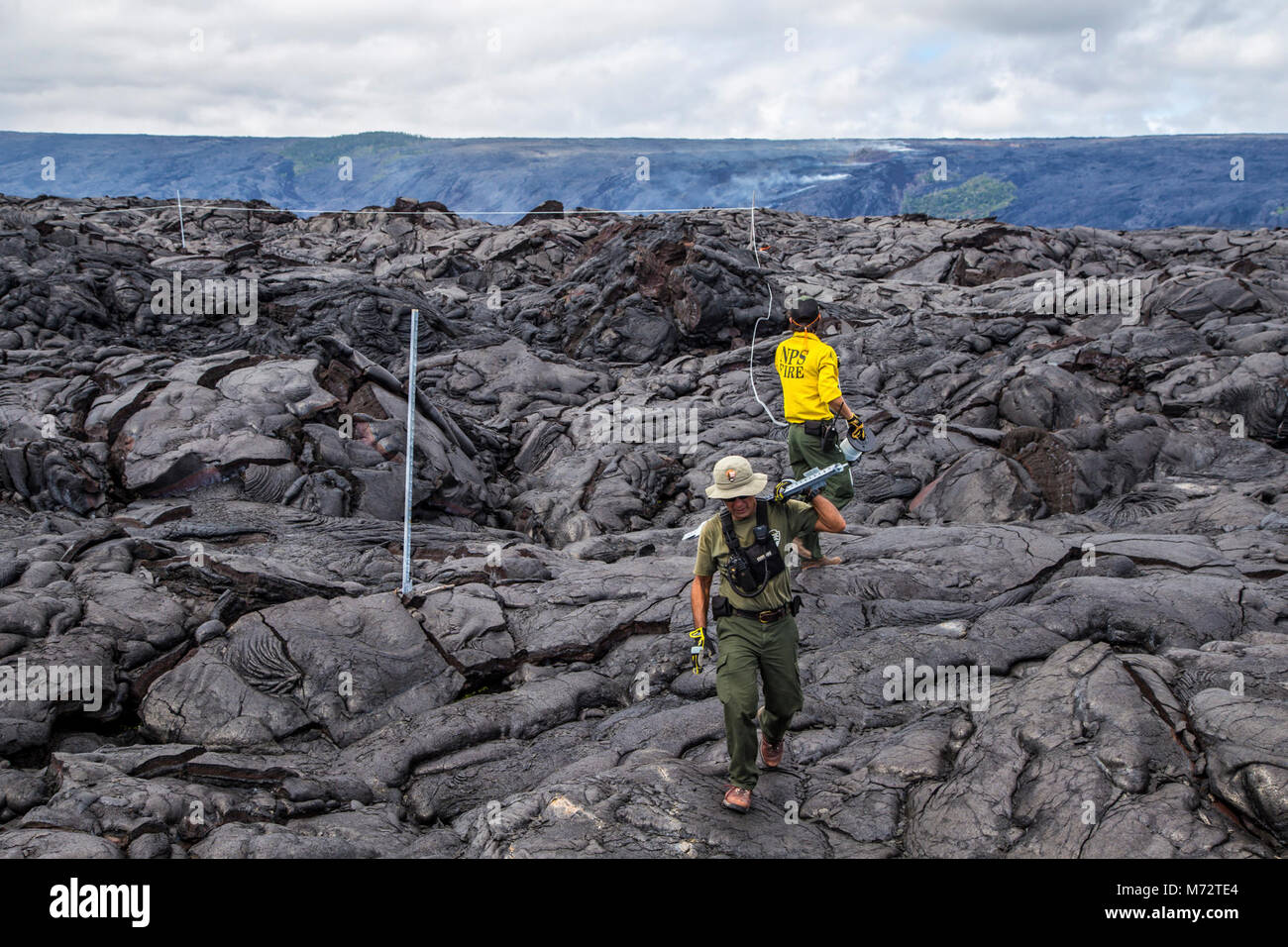Eruption crew rangers relocate rope line inland of ocean entry Stock ...