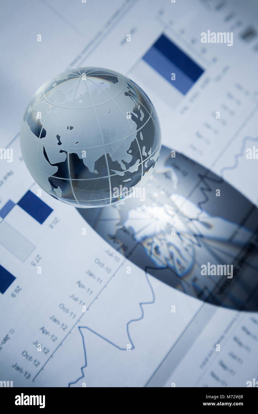 Glass globe on the chart papers Stock Photo - Alamy