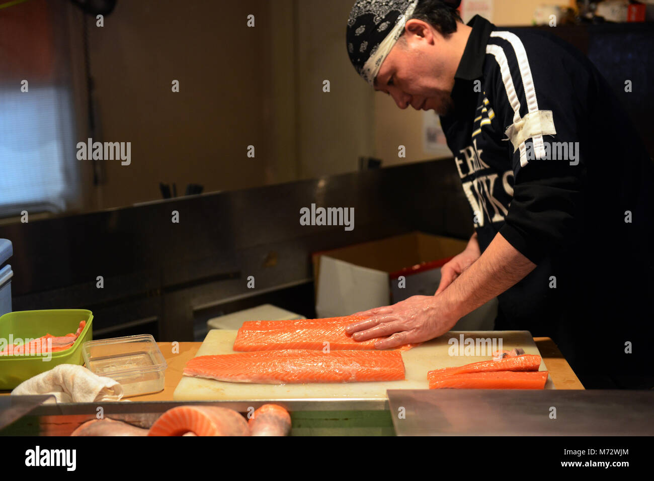 A Sushi chef cutting the fish Stock Photo - Alamy