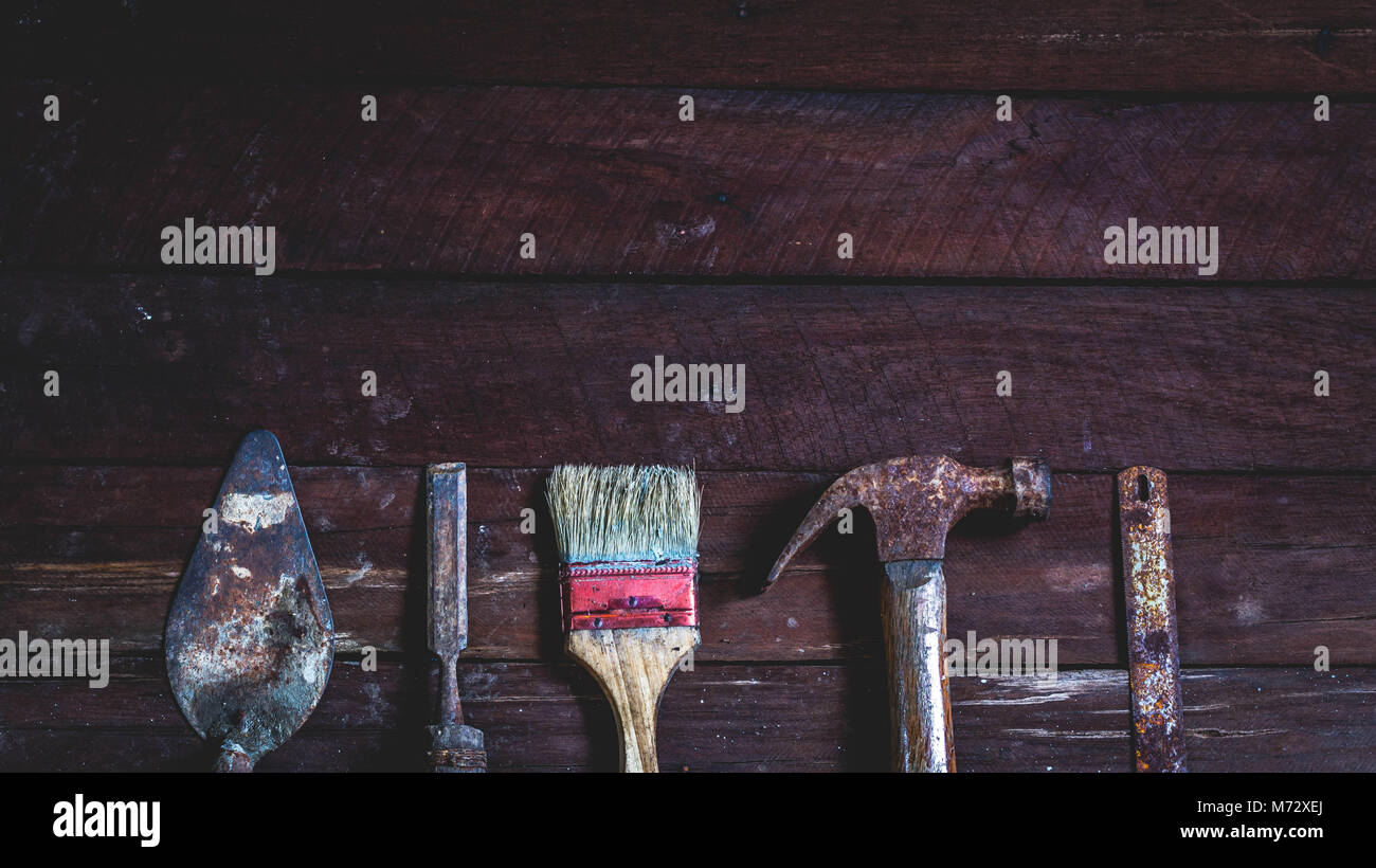 old and rusty construction or carpentry tools on wooden table; hacksaw ...