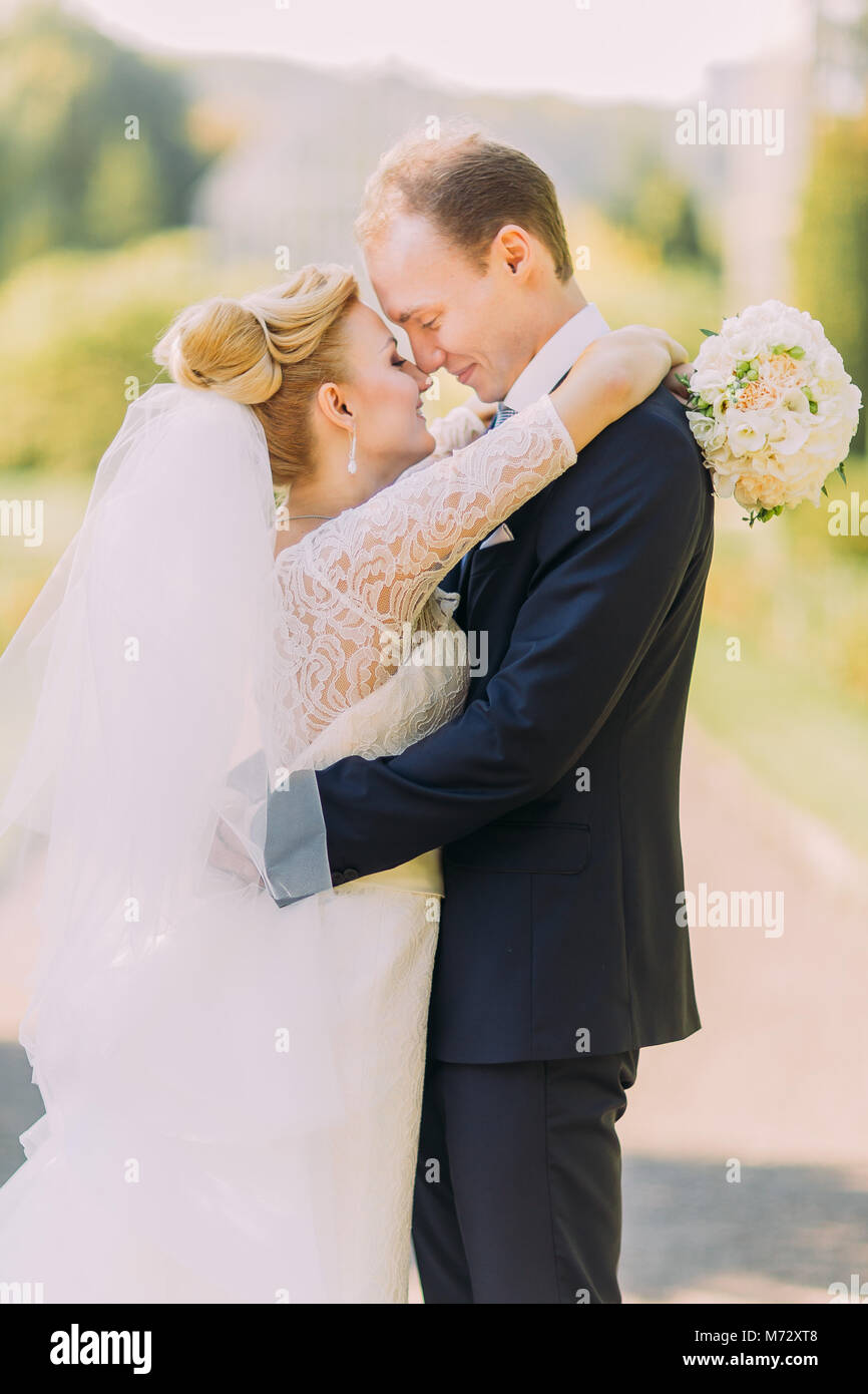 Happy young attractive couple lovingly look at each other in the spring ...
