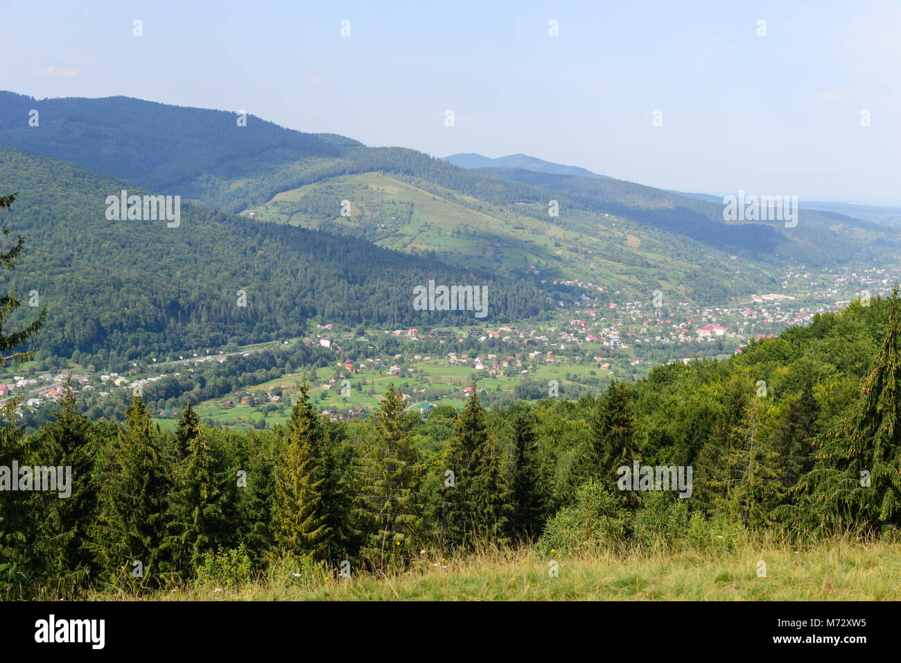 Landscape village between mountains and forest. Photo nature Stock ...